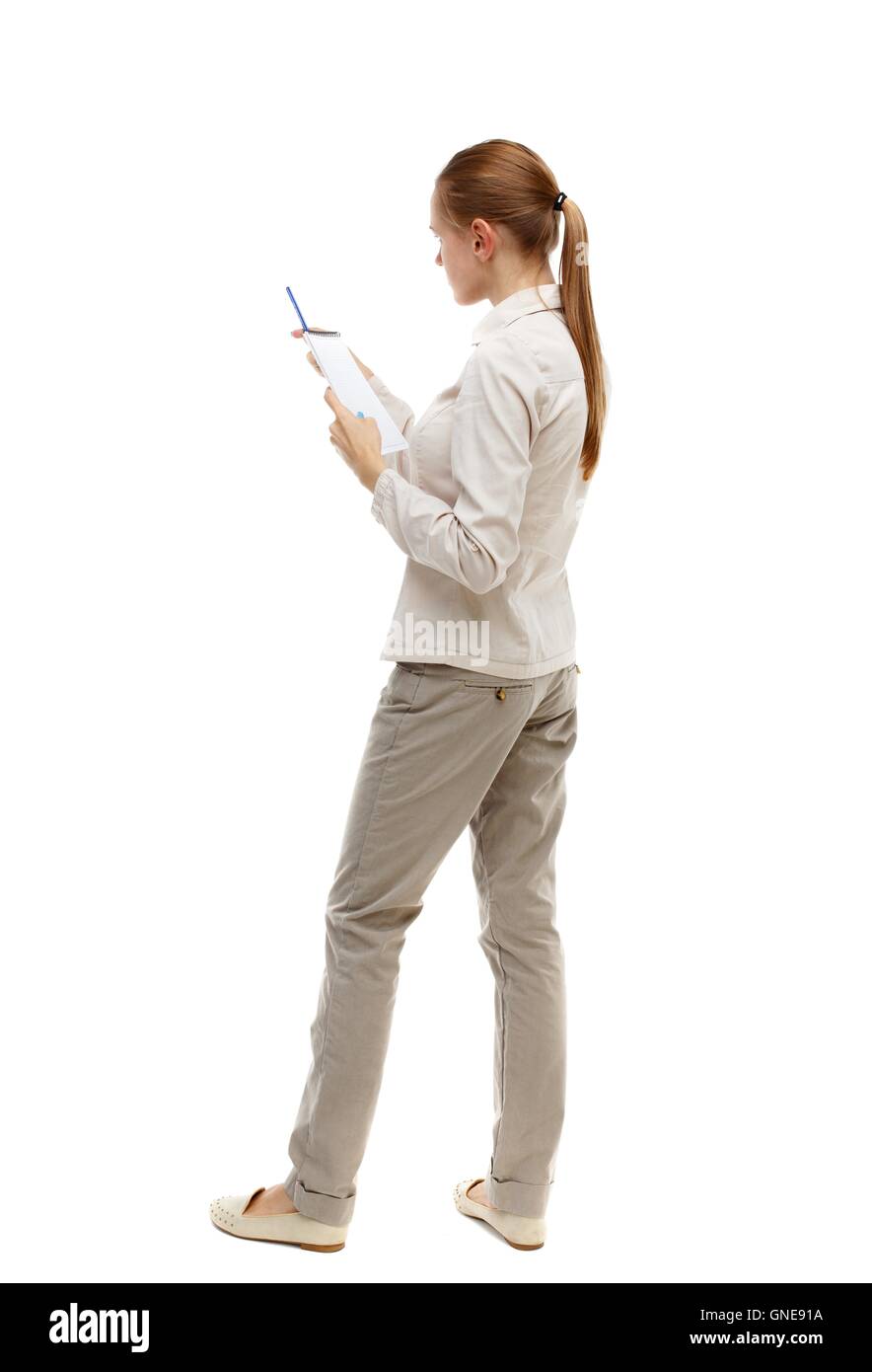 back view of stands woman takes notes in a notebook Stock Photo - Alamy