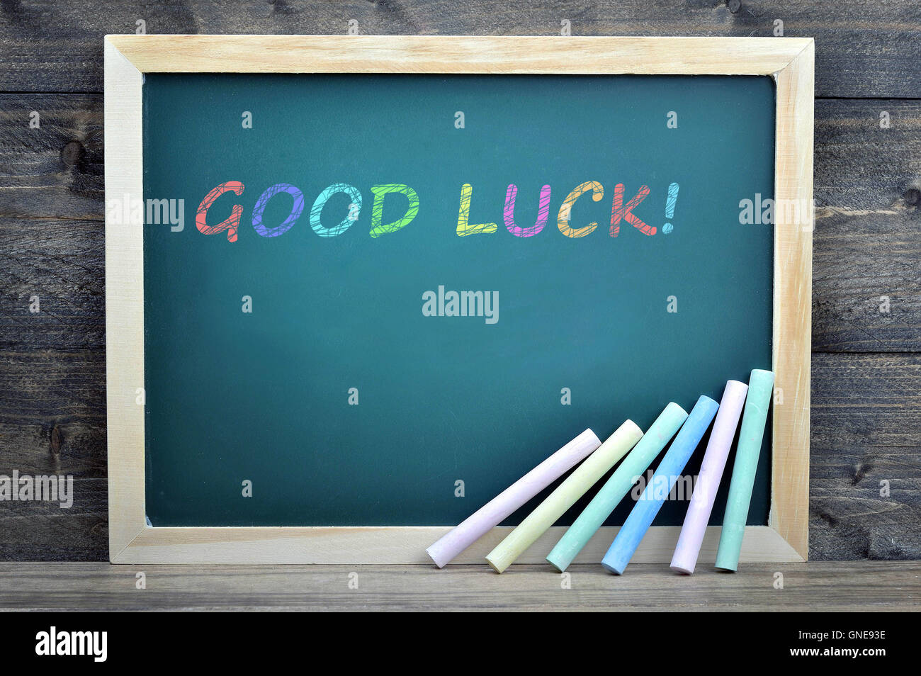Good Luck text on school board and chalk on wooden table Stock Photo ...
