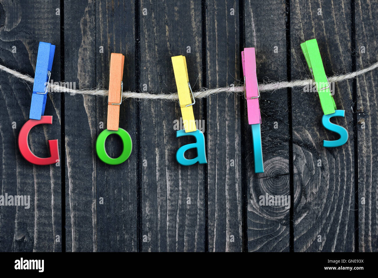Goals word hanging on clips and wooden wall Stock Photo - Alamy