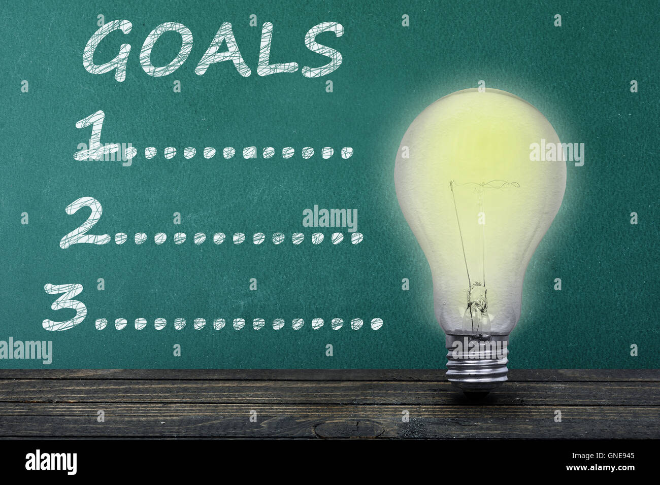 Goals list on green board and light bulb on table Stock Photo - Alamy