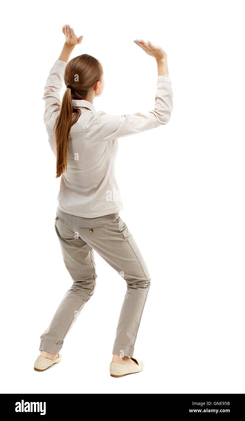 back view of woman protects hands from what is falling Stock Photo - Alamy