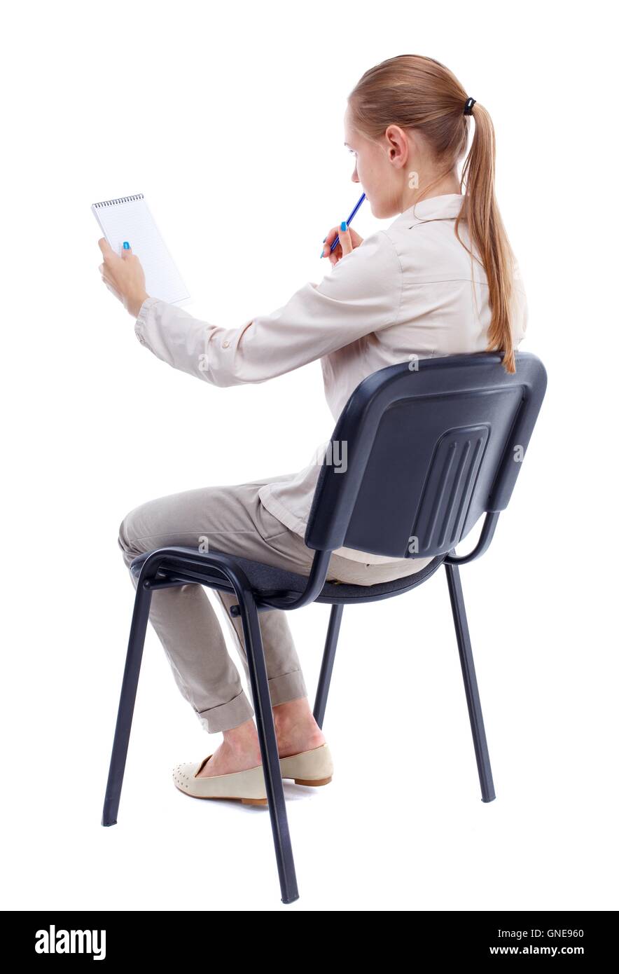 back view of young beautiful woman sitting on chair and takes Stock ...
