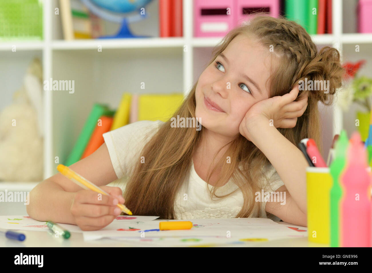 Little girl drawing at class Stock Photo - Alamy