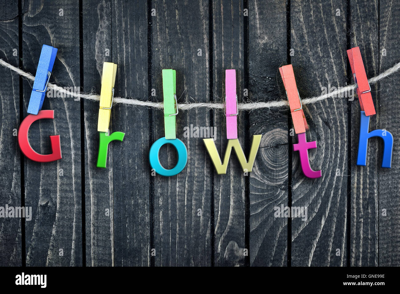 Growth word hanging on clips and wooden wall Stock Photo - Alamy