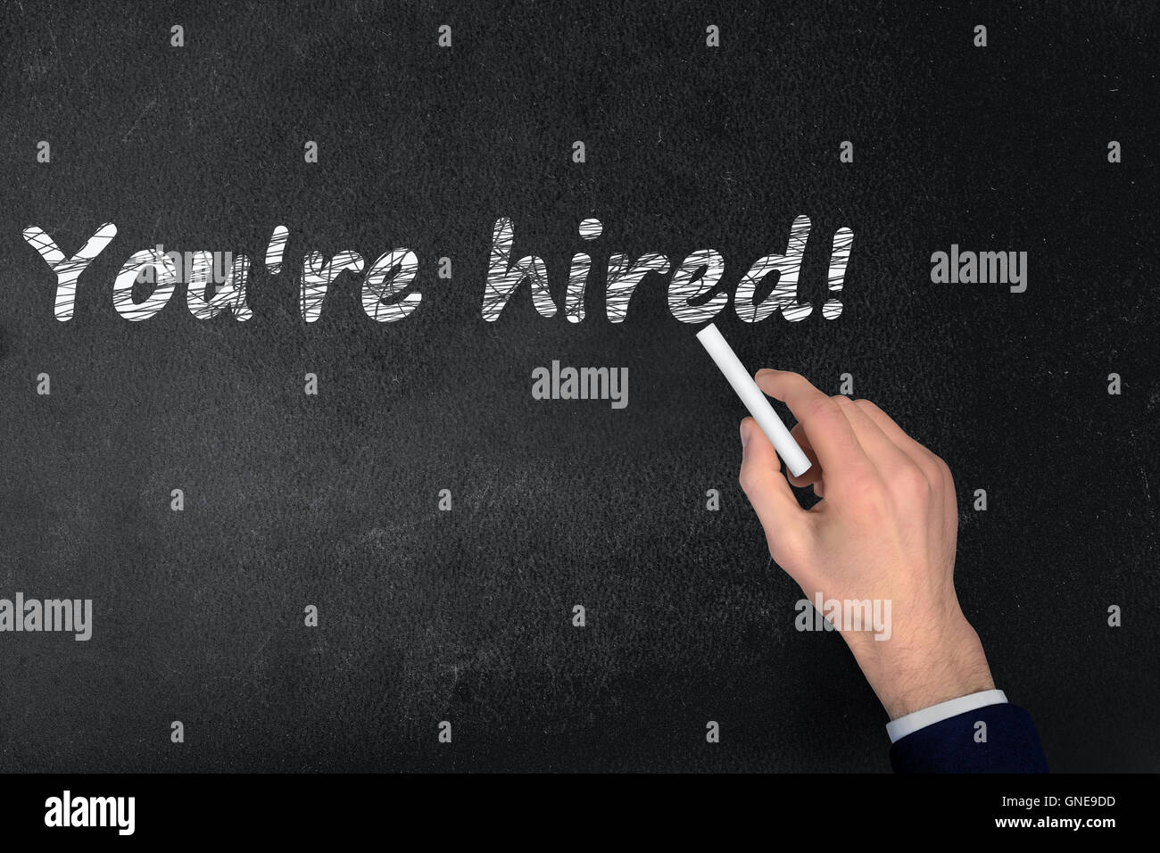 You're hired text write on black board Stock Photo - Alamy