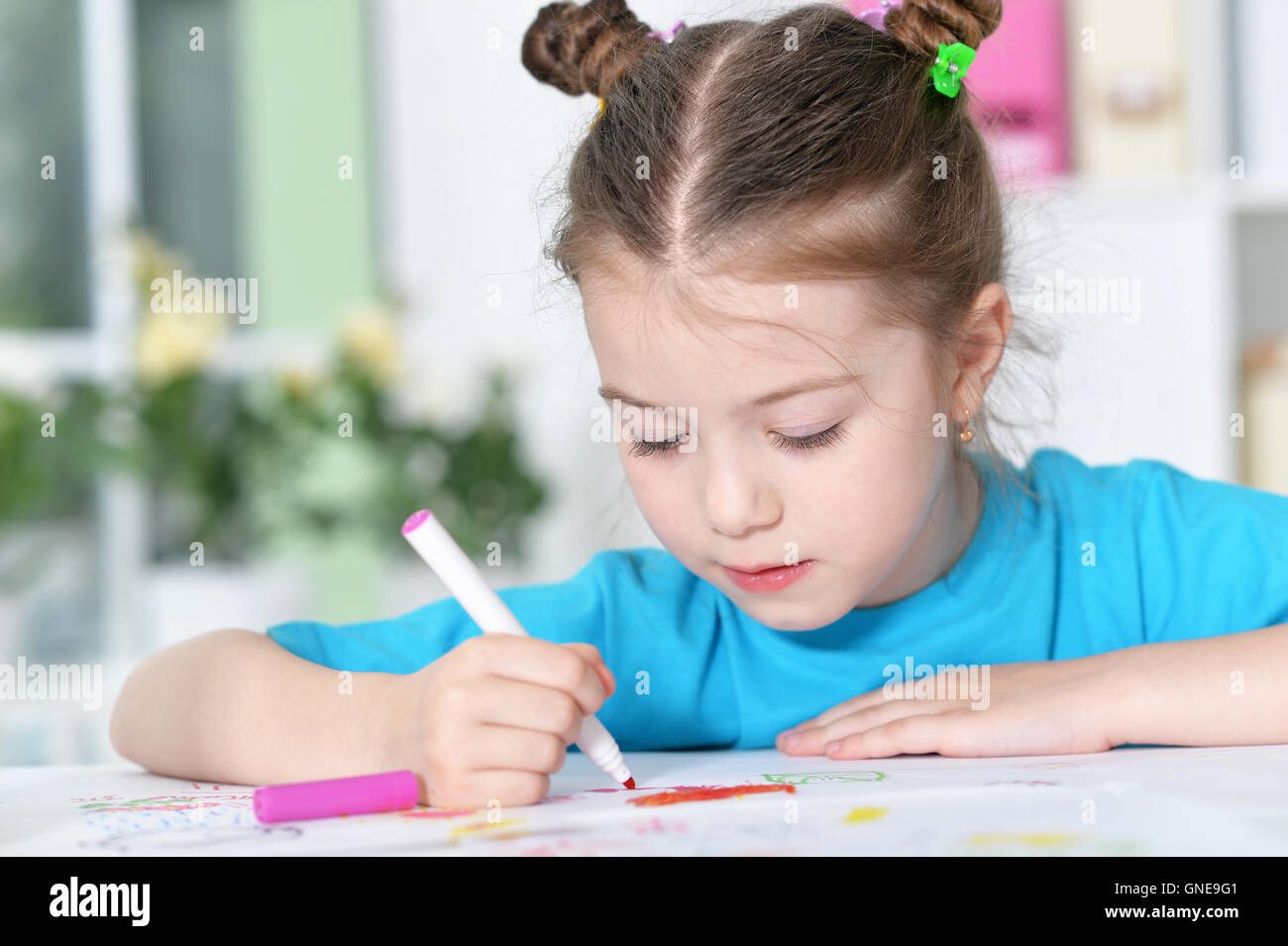 Little girl drawing at class Stock Photo - Alamy