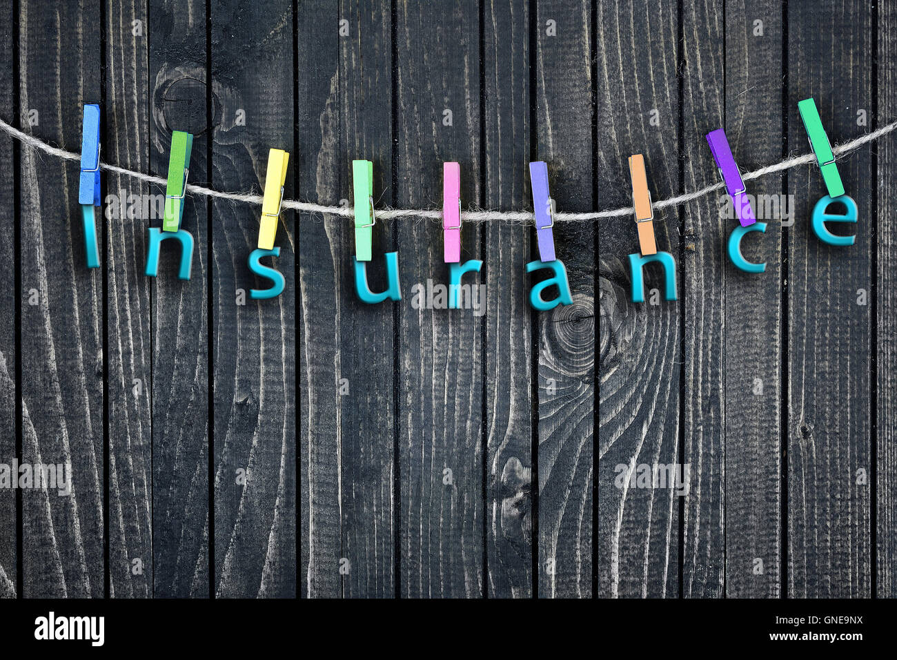 Insurance word hanging on clips and wooden wall Stock Photo - Alamy