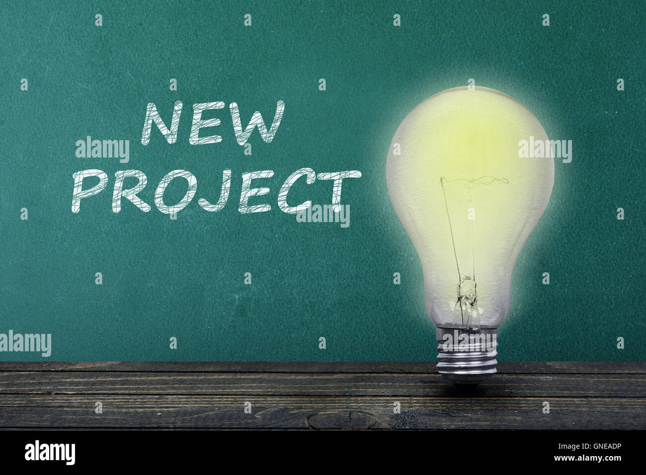 New Project text on green board and light bulb on table Stock Photo - Alamy
