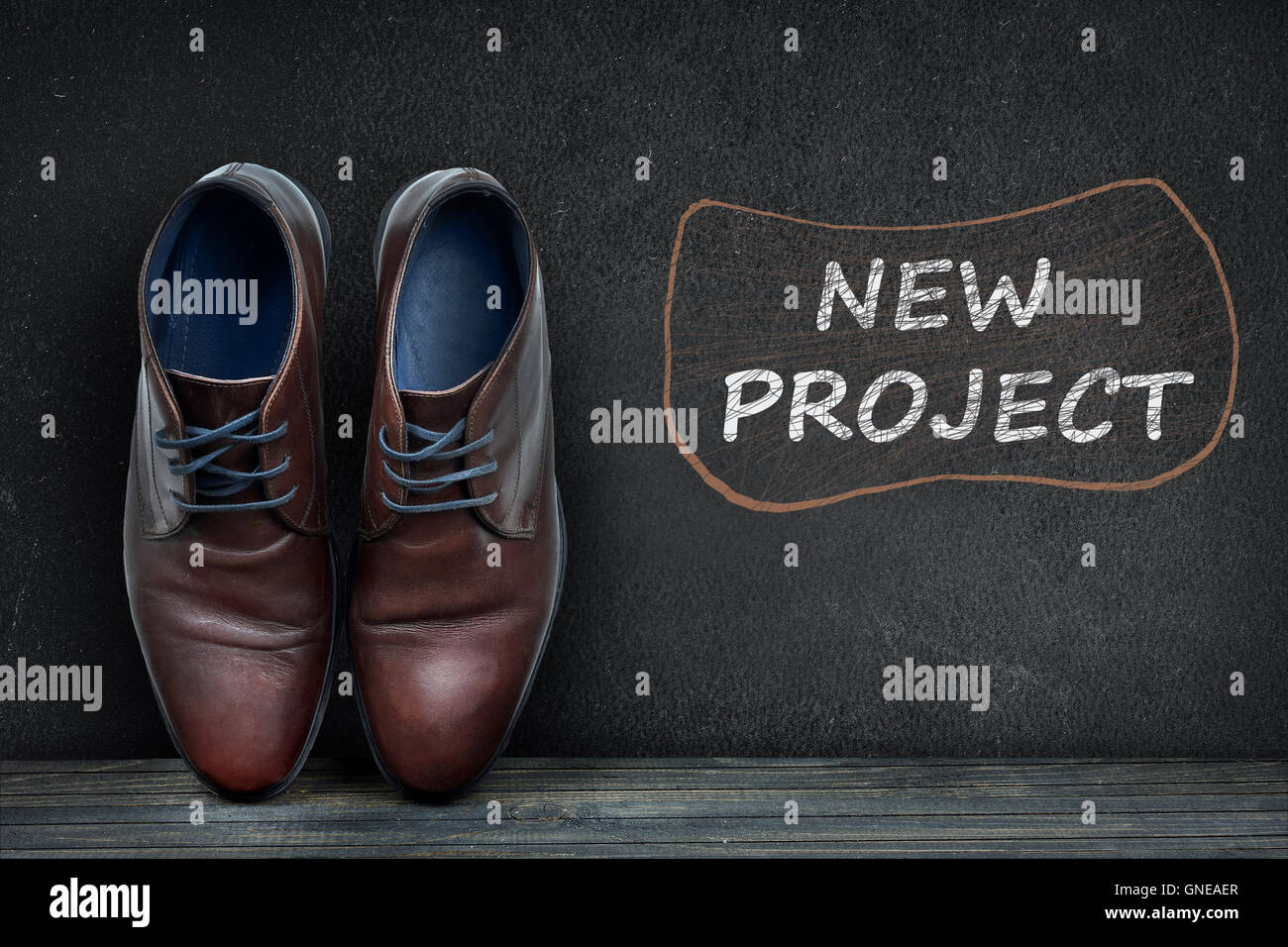 New Project text on black board and business shoes on wooden floor ...