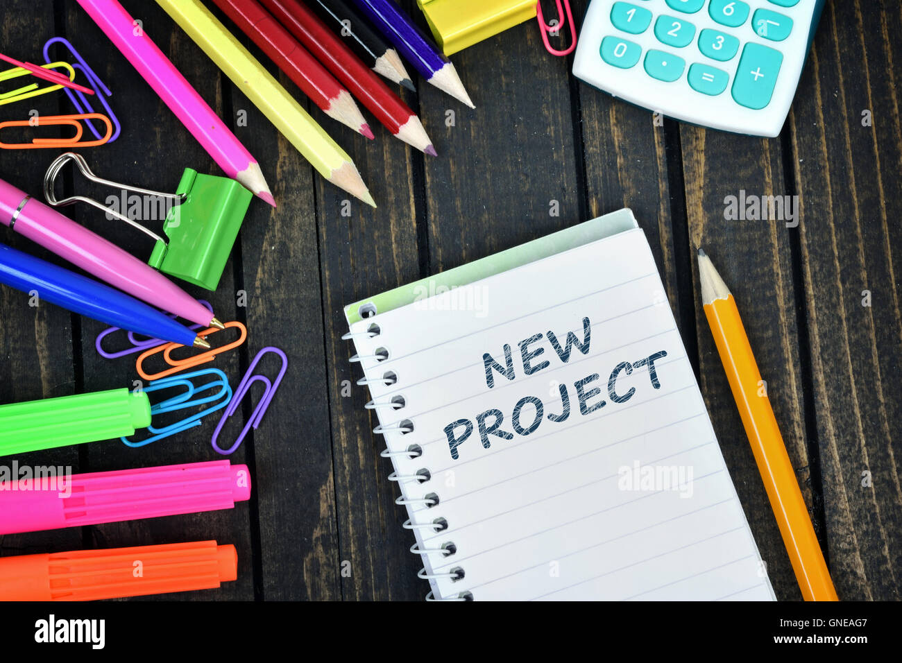 New Project text on notepad and office tools on wooden table Stock ...