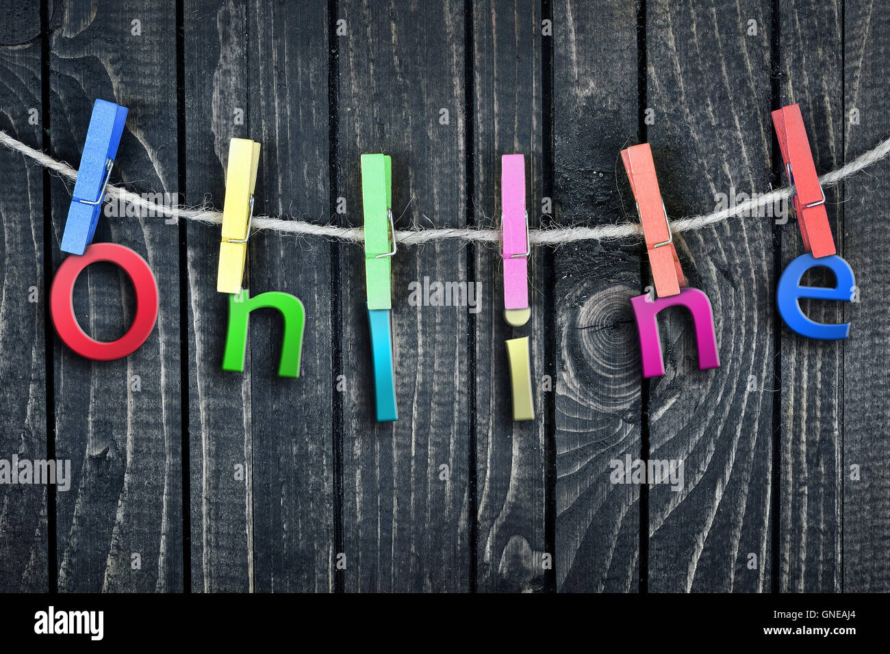 Online word hanging on clips and wooden wall Stock Photo - Alamy