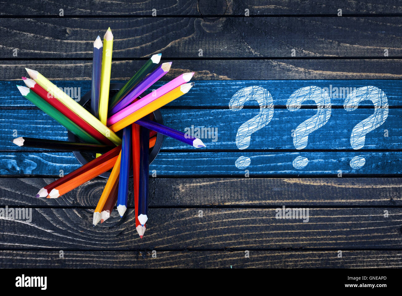 Question marks painted and group of pencils on wooden table Stock Photo ...
