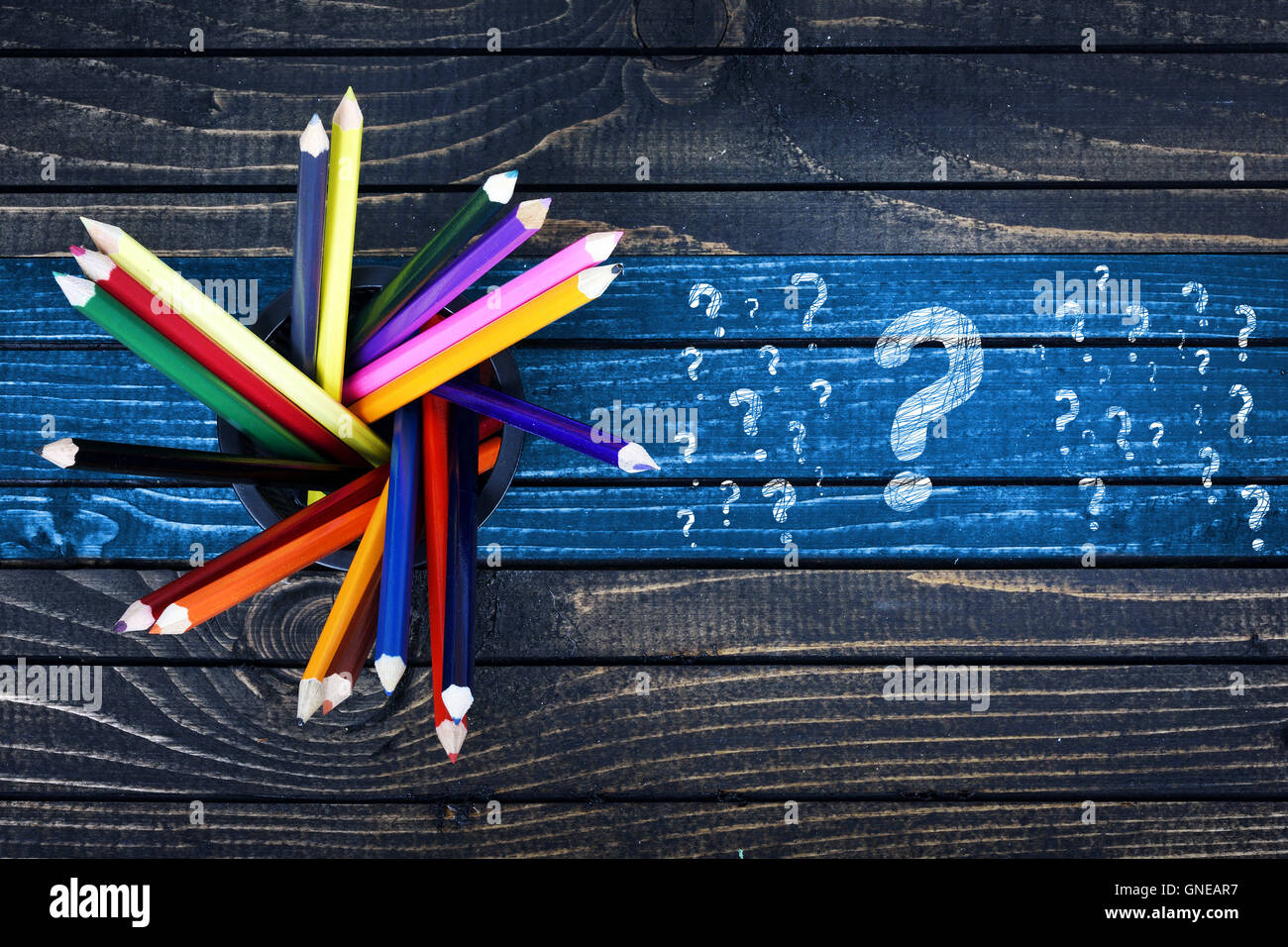 Question marks painted and group of pencils on wooden table Stock Photo ...