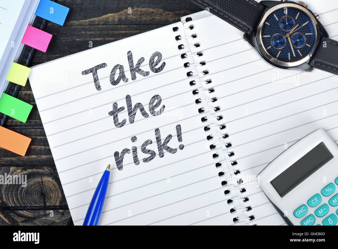 Take the risk text on notepad and watch on desk Stock Photo - Alamy