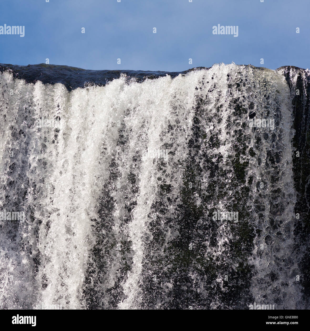 Water cascading over rock edge forming a waterfall Stock Photo - Alamy