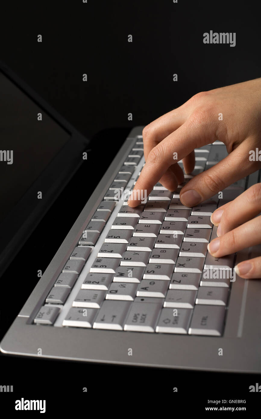 fingers over notebook keyboard Stock Photo - Alamy