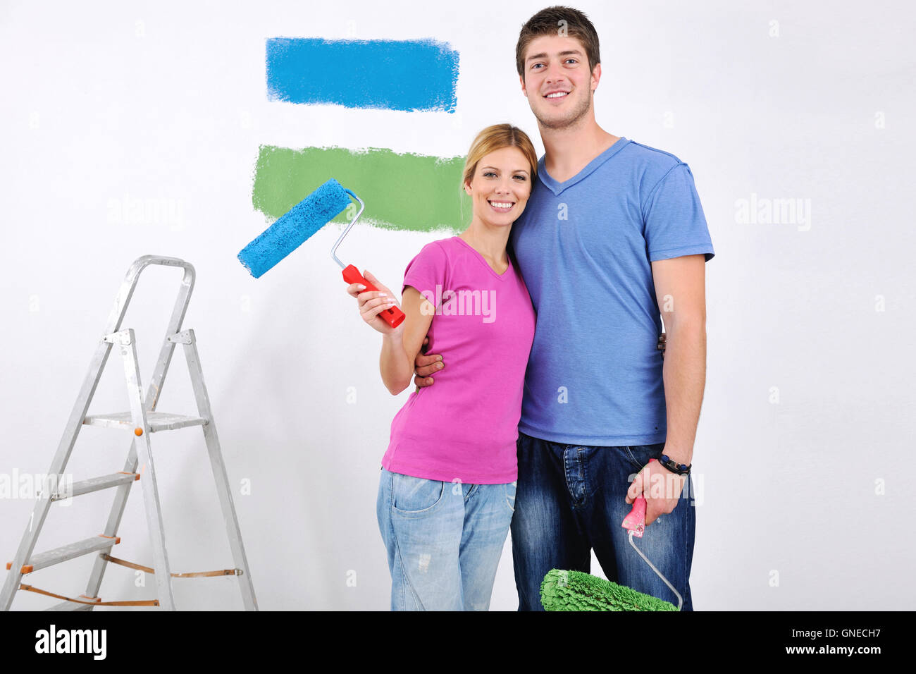 happy couple paint wall at new home Stock Photo - Alamy