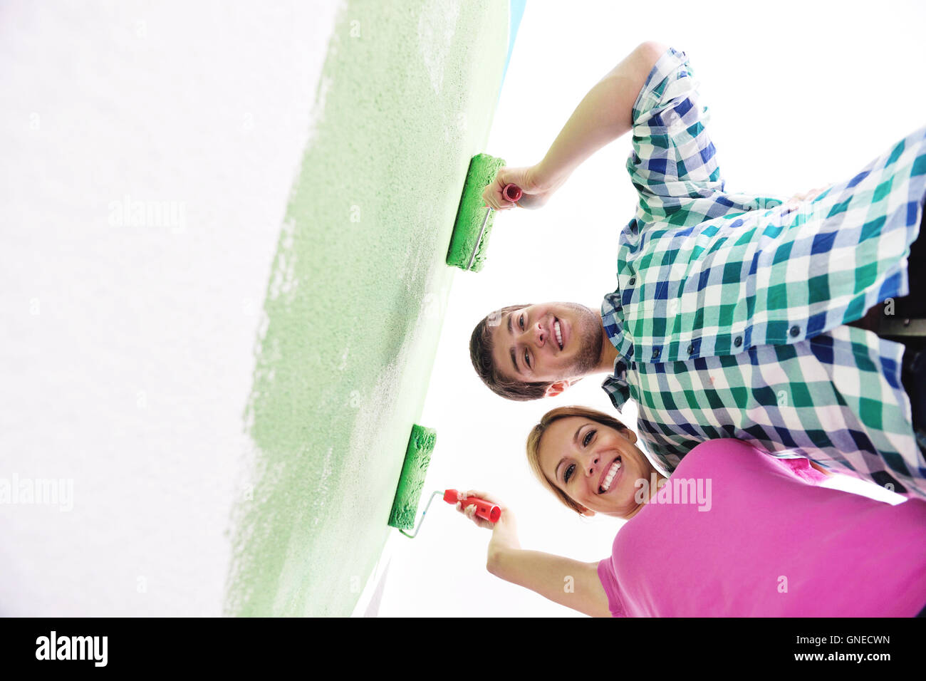 happy couple paint wall at new home Stock Photo - Alamy