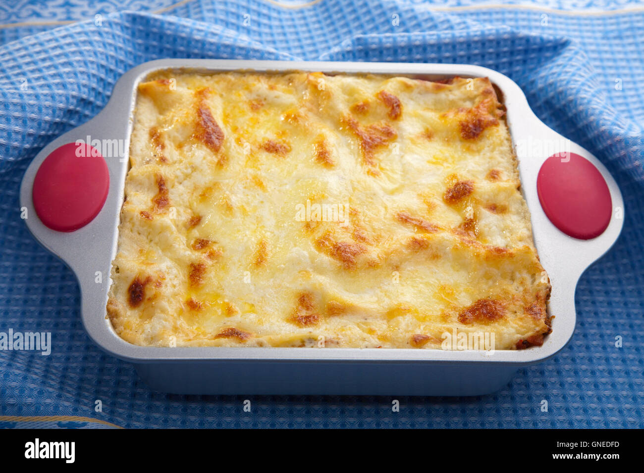 classic lasagna over blue cloth Stock Photo - Alamy