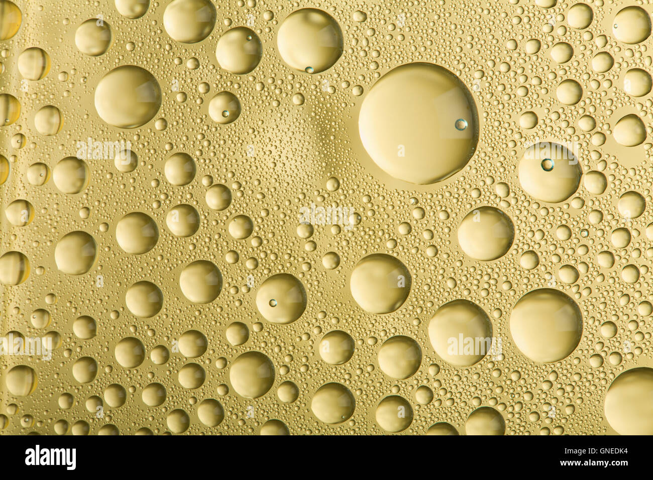 golden water drops background Stock Photo - Alamy