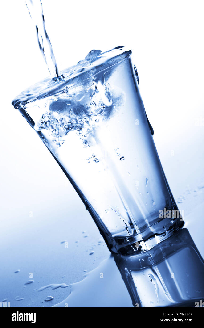 water splashing into glass with ice cubes Stock Photo - Alamy