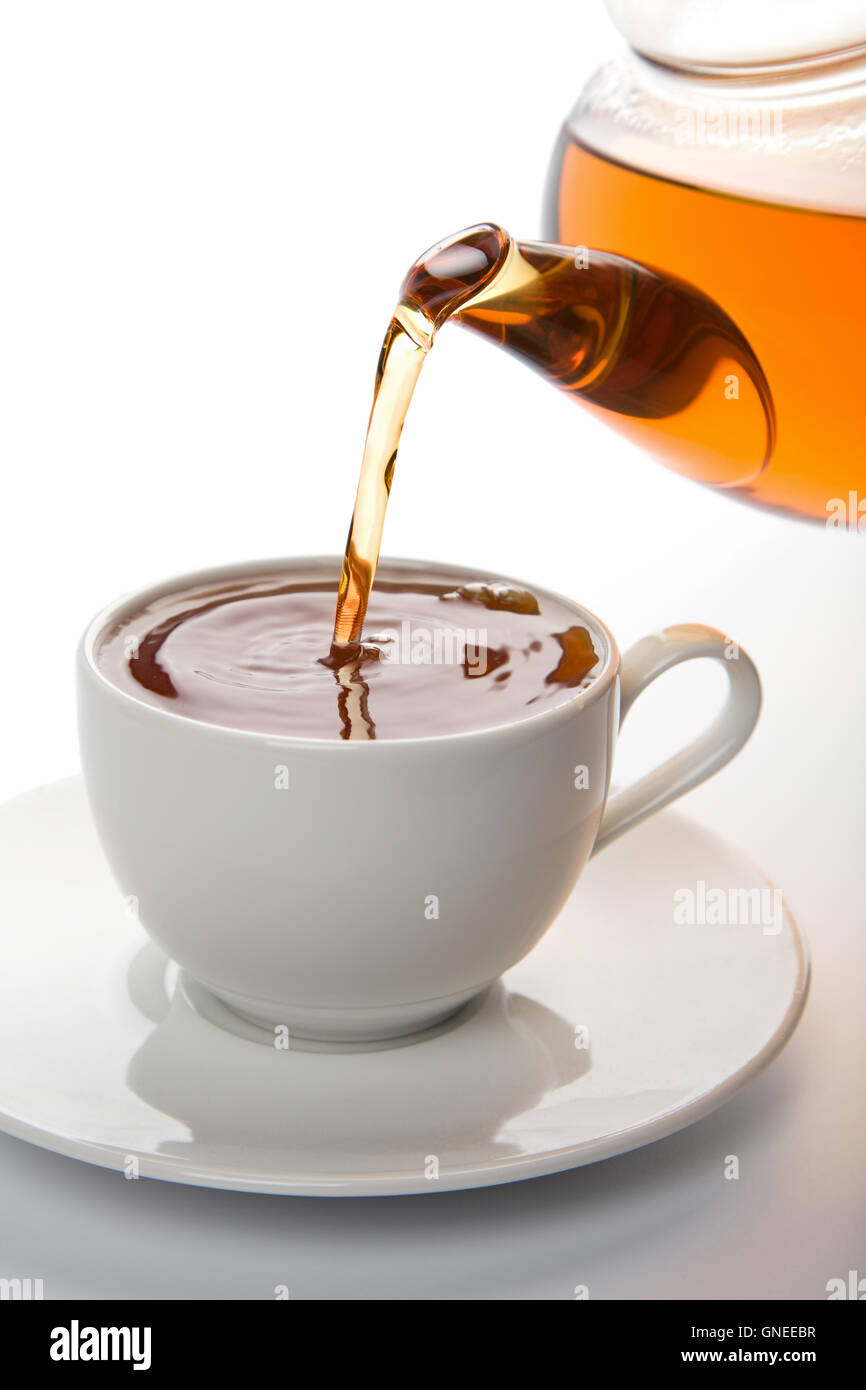 tea pouring into white cup isolated Stock Photo - Alamy