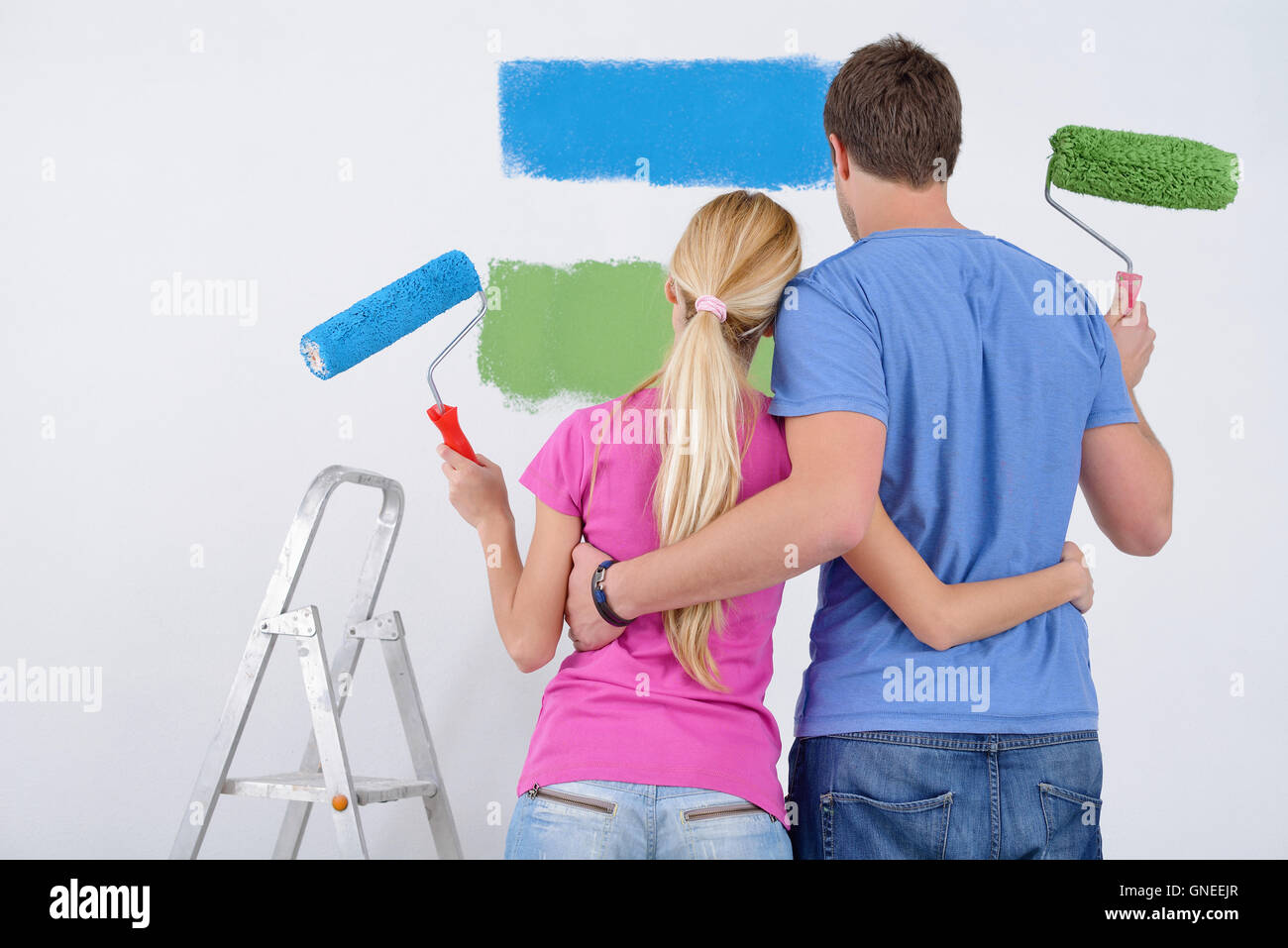 happy couple paint wall at new home Stock Photo - Alamy