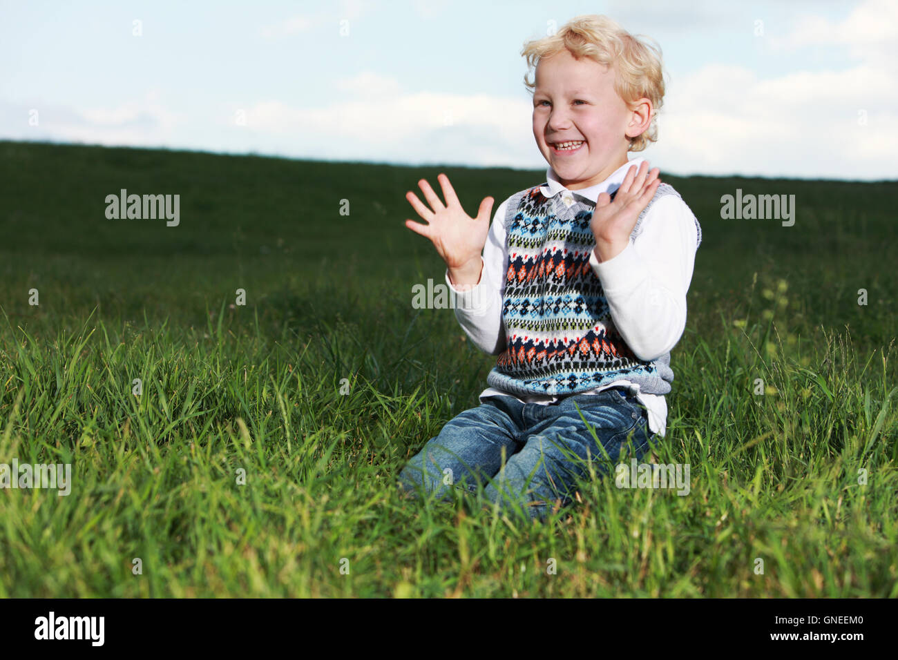 Little boy clapping his hands in glee Stock Photo - Alamy