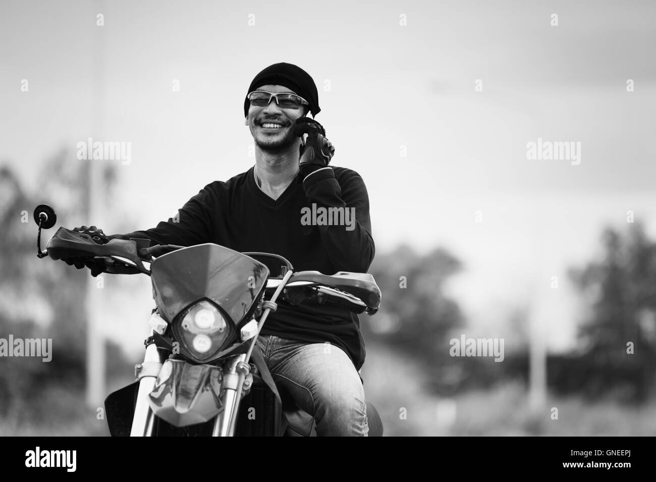portrait of asia handsome man biker call phone on the motorcycle ...