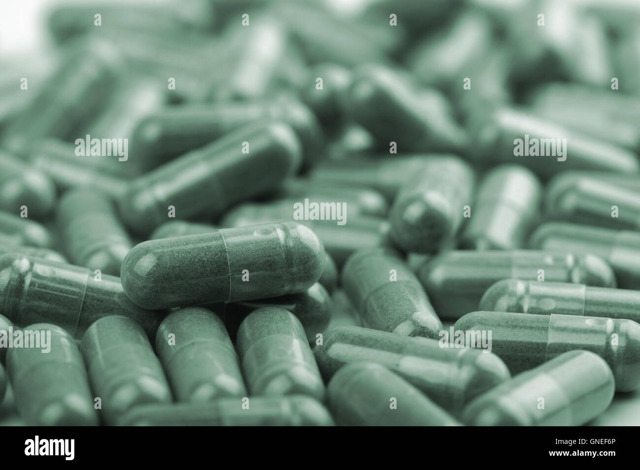 green capsule pills Stock Photo - Alamy