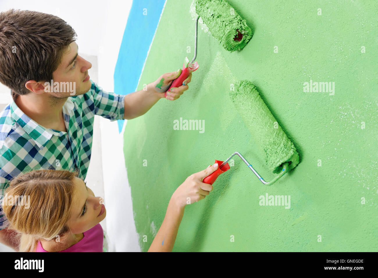 happy couple paint wall at new home Stock Photo - Alamy