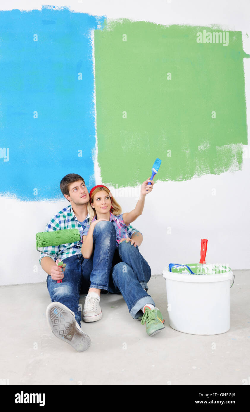 happy couple paint wall at new home Stock Photo - Alamy