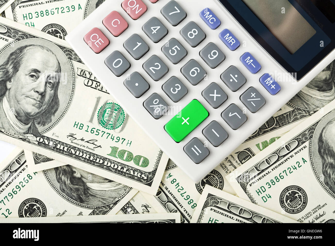 dollars and calculator Stock Photo - Alamy