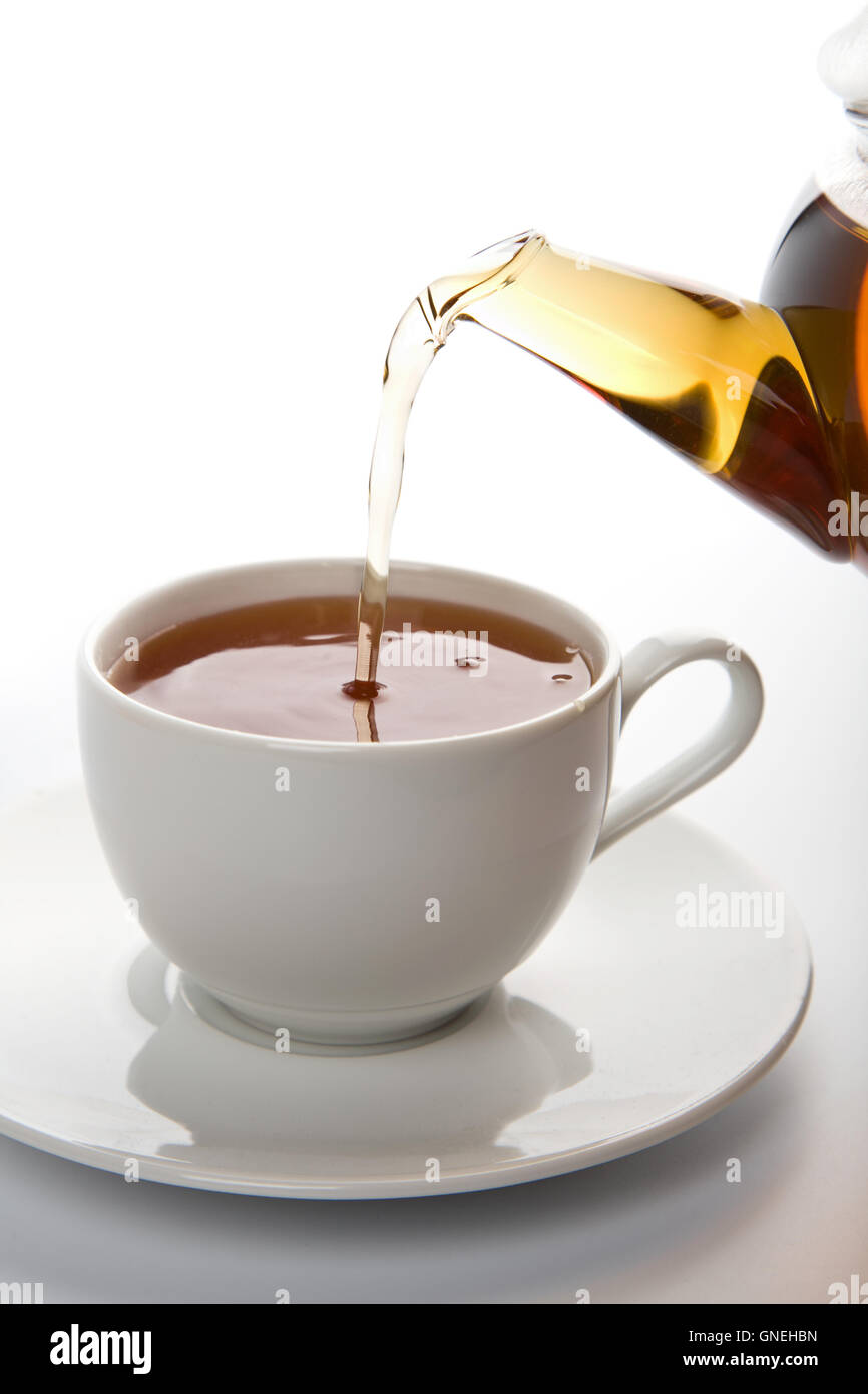 tea pouring into white cup isolated Stock Photo - Alamy