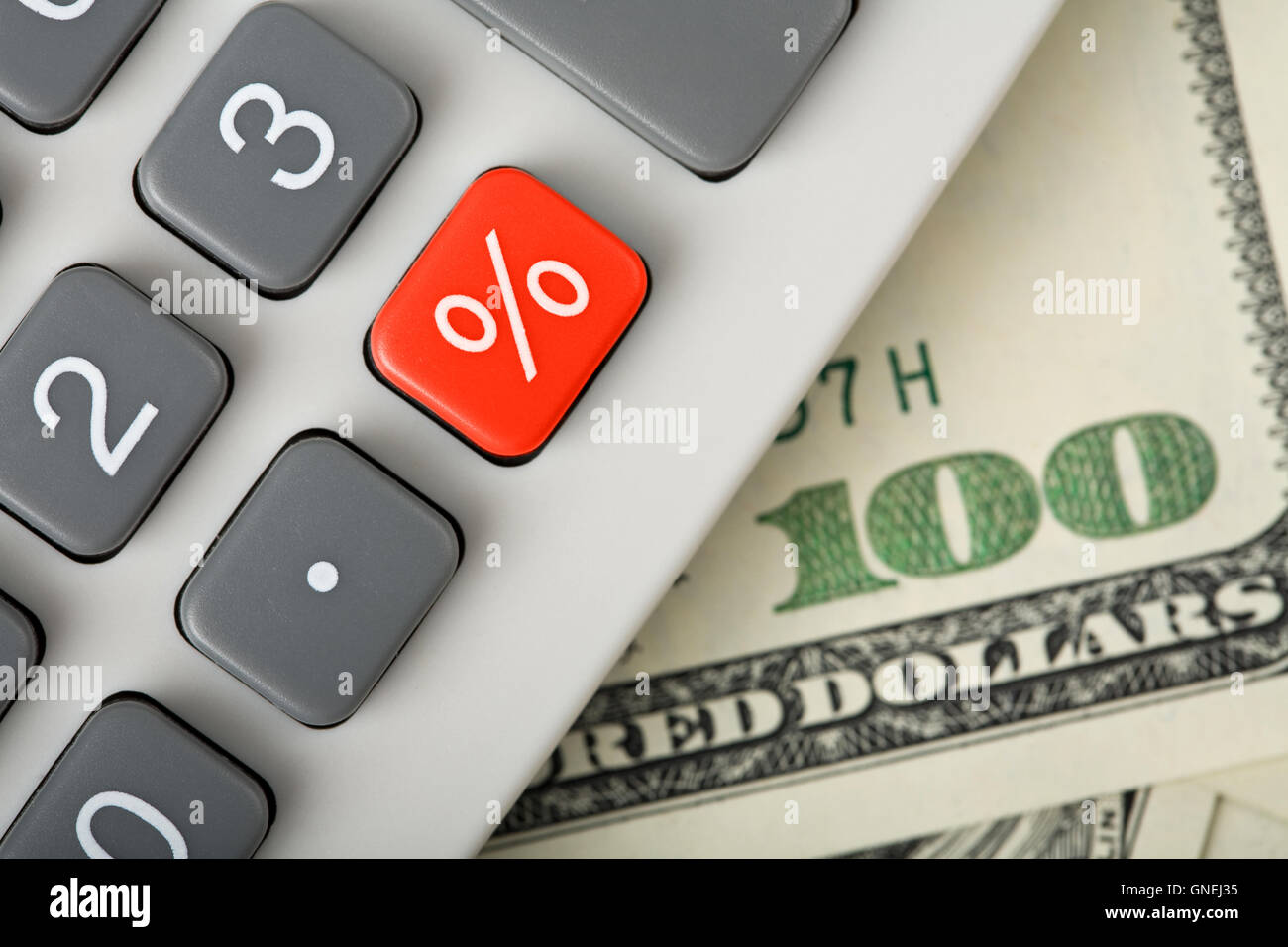 dollars and calculator with percent red button Stock Photo - Alamy