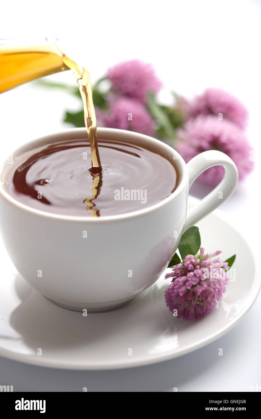 tea pouring into white cup isolated Stock Photo - Alamy