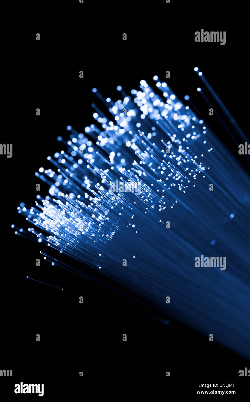 blue fiber optic isolated over black Stock Photo - Alamy