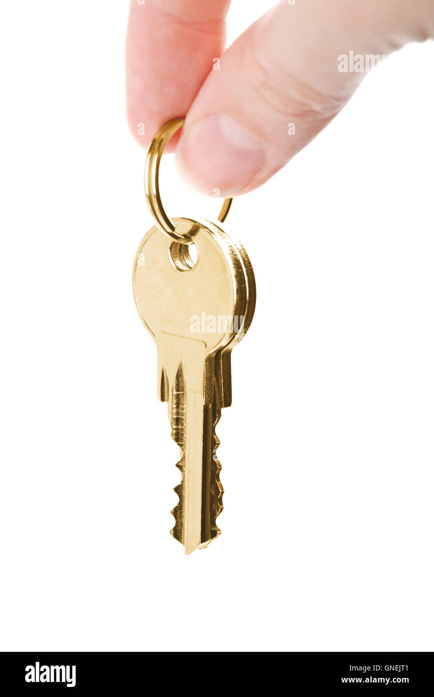 fingers holding golden keys isolated Stock Photo - Alamy