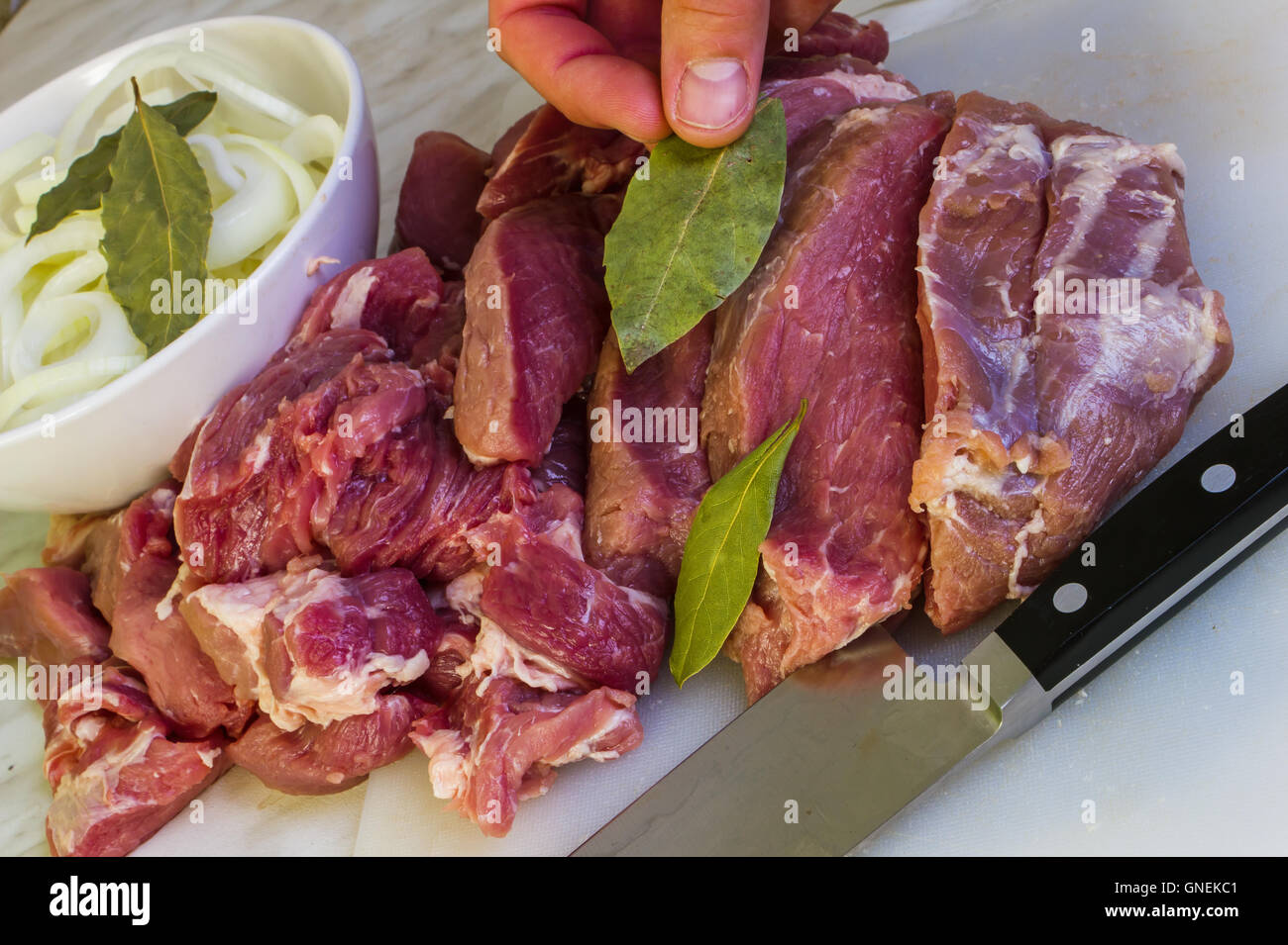 Cutting raw meat Stock Photo - Alamy