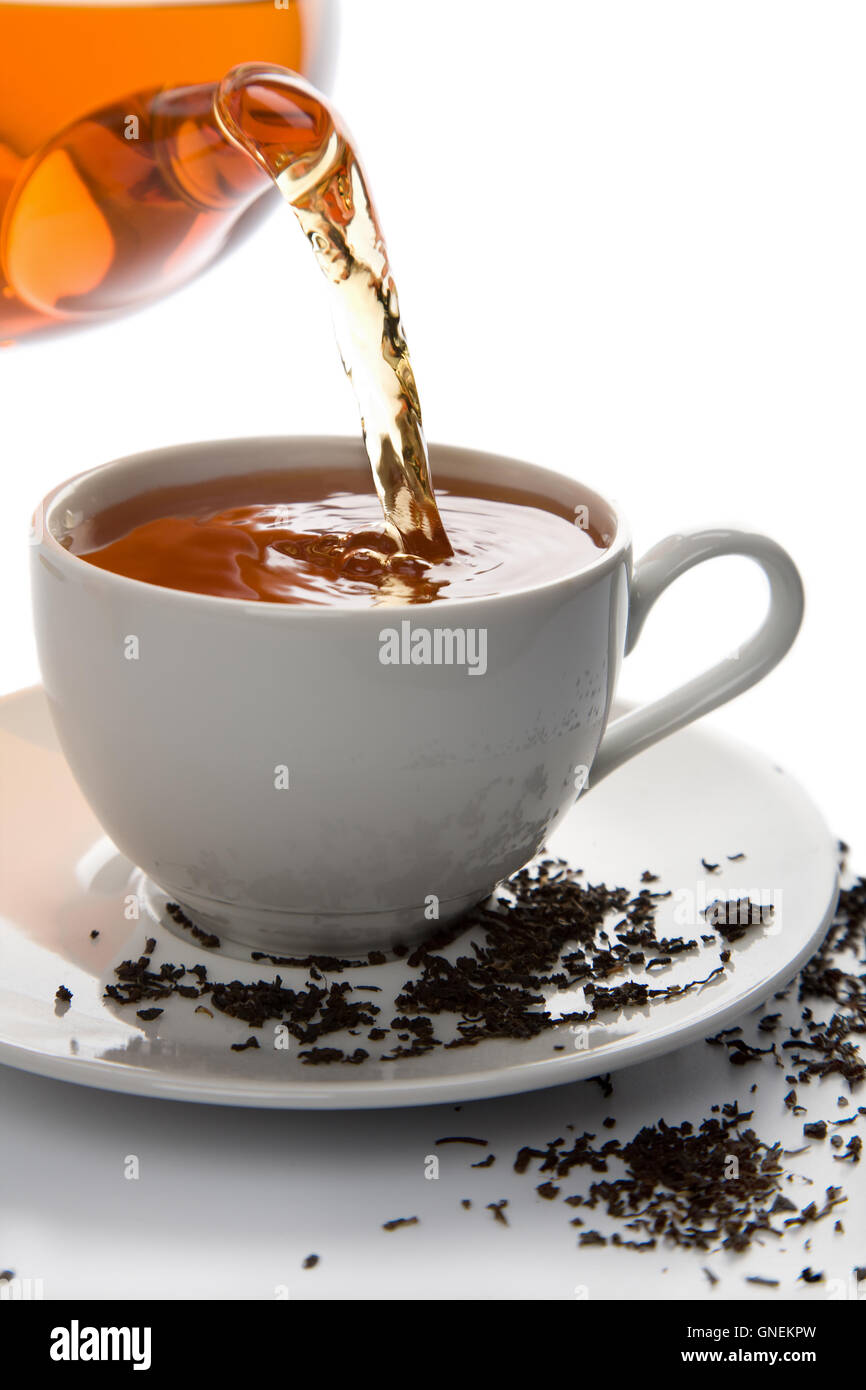 tea pouring into white cup isolated Stock Photo - Alamy