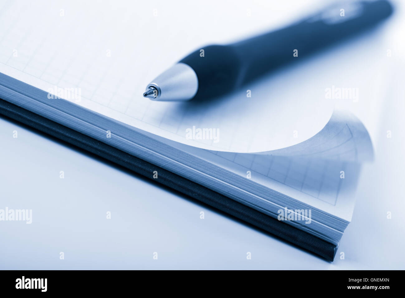 notebook and pen toned blue Stock Photo - Alamy