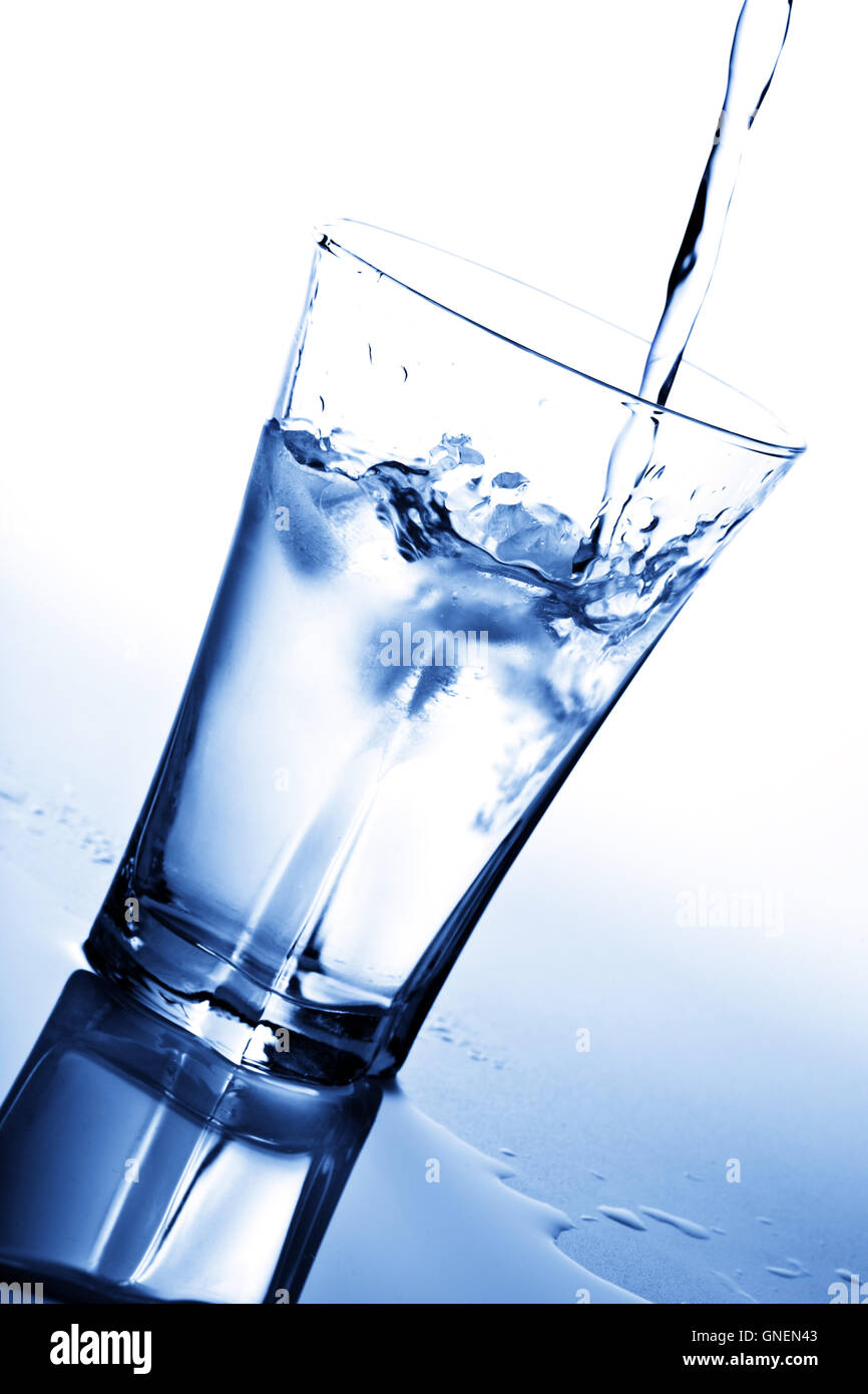 water splashing into glass with ice cubes Stock Photo - Alamy