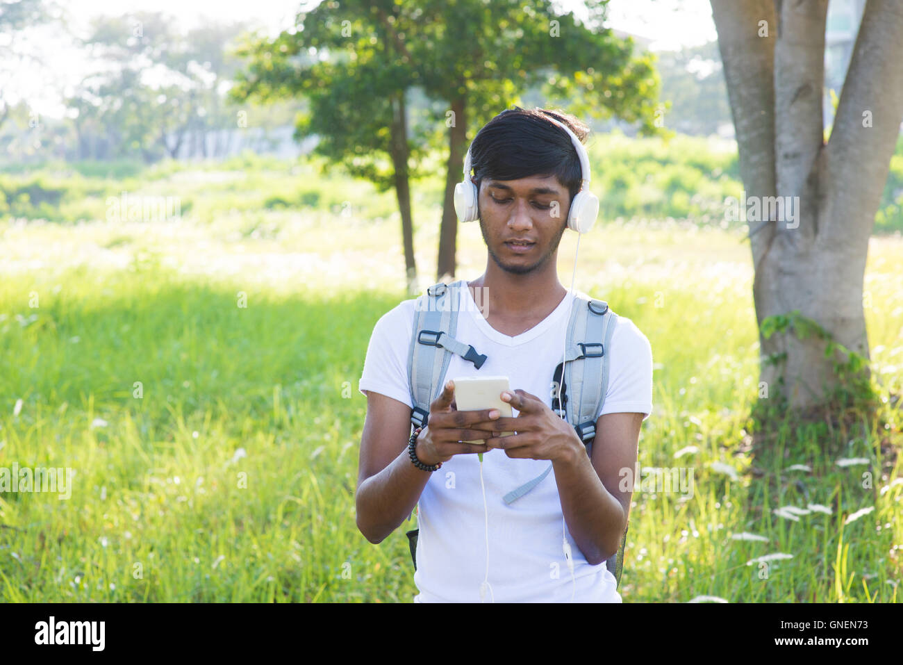indian male college student listening to music outdoor Stock Photo - Alamy