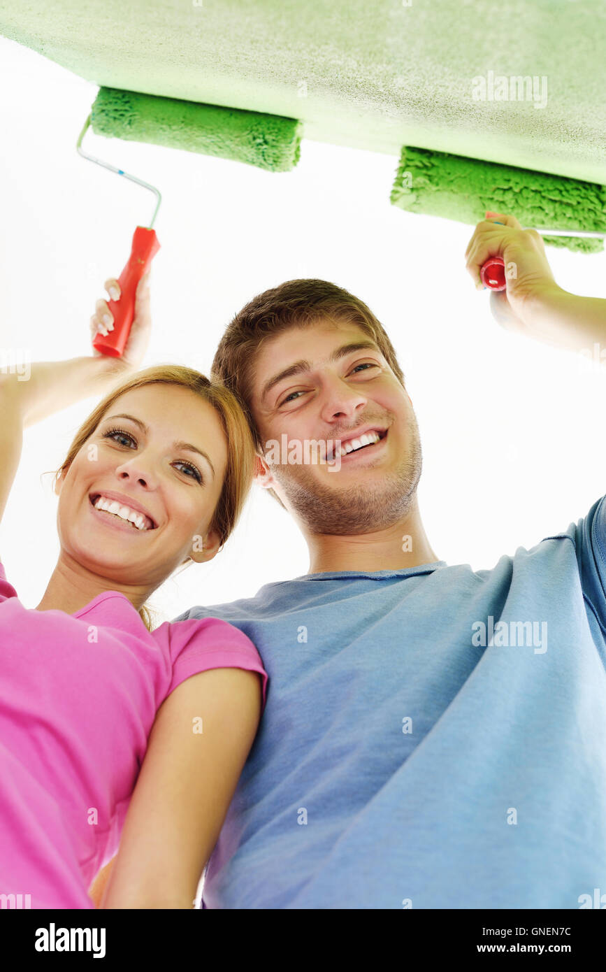 happy couple paint wall at new home Stock Photo - Alamy