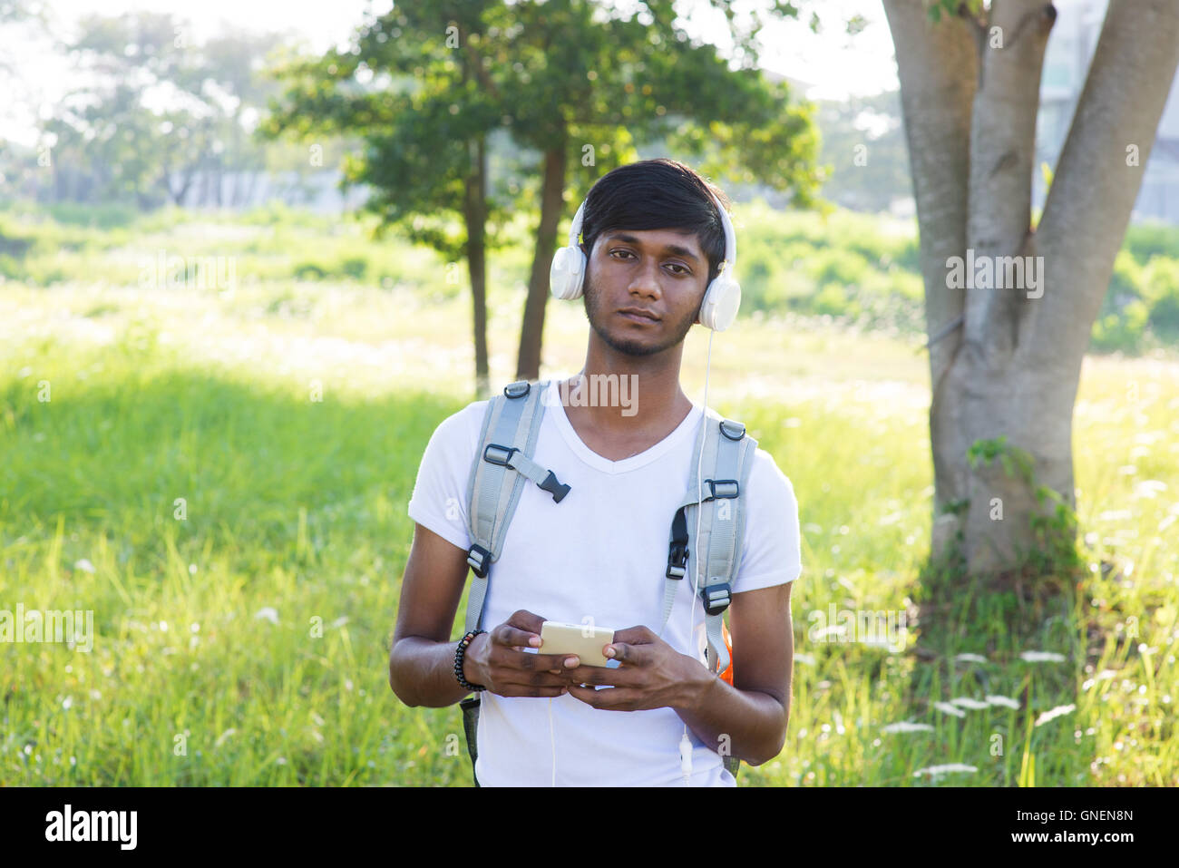 indian male college student listening to music outdoor Stock Photo - Alamy