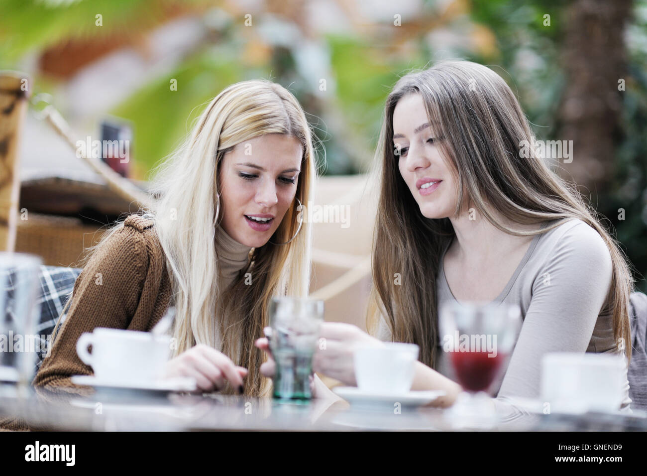 cute smiling women drinking a coffee Stock Photo - Alamy