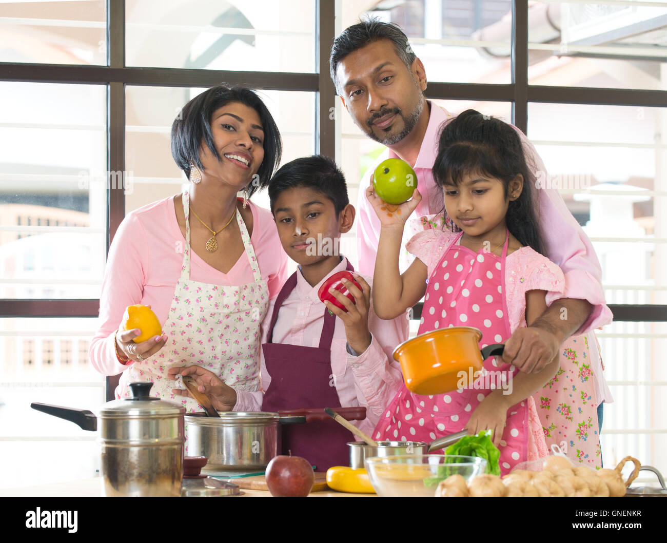 indian family spending quality time busy cooking at home Stock Photo ...