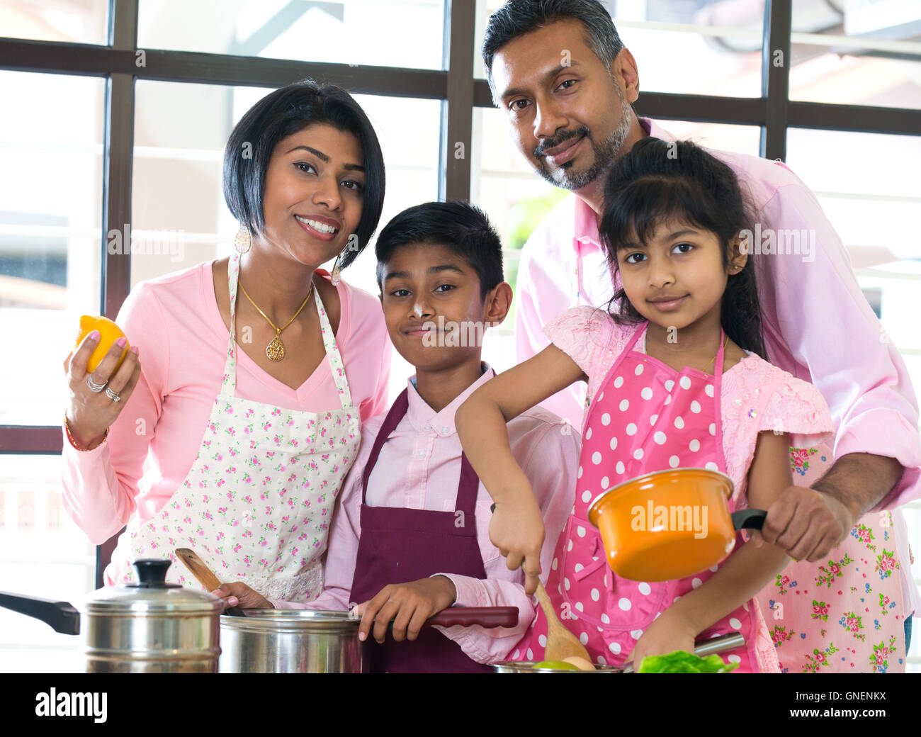 indian family spending quality time busy cooking at home Stock Photo ...