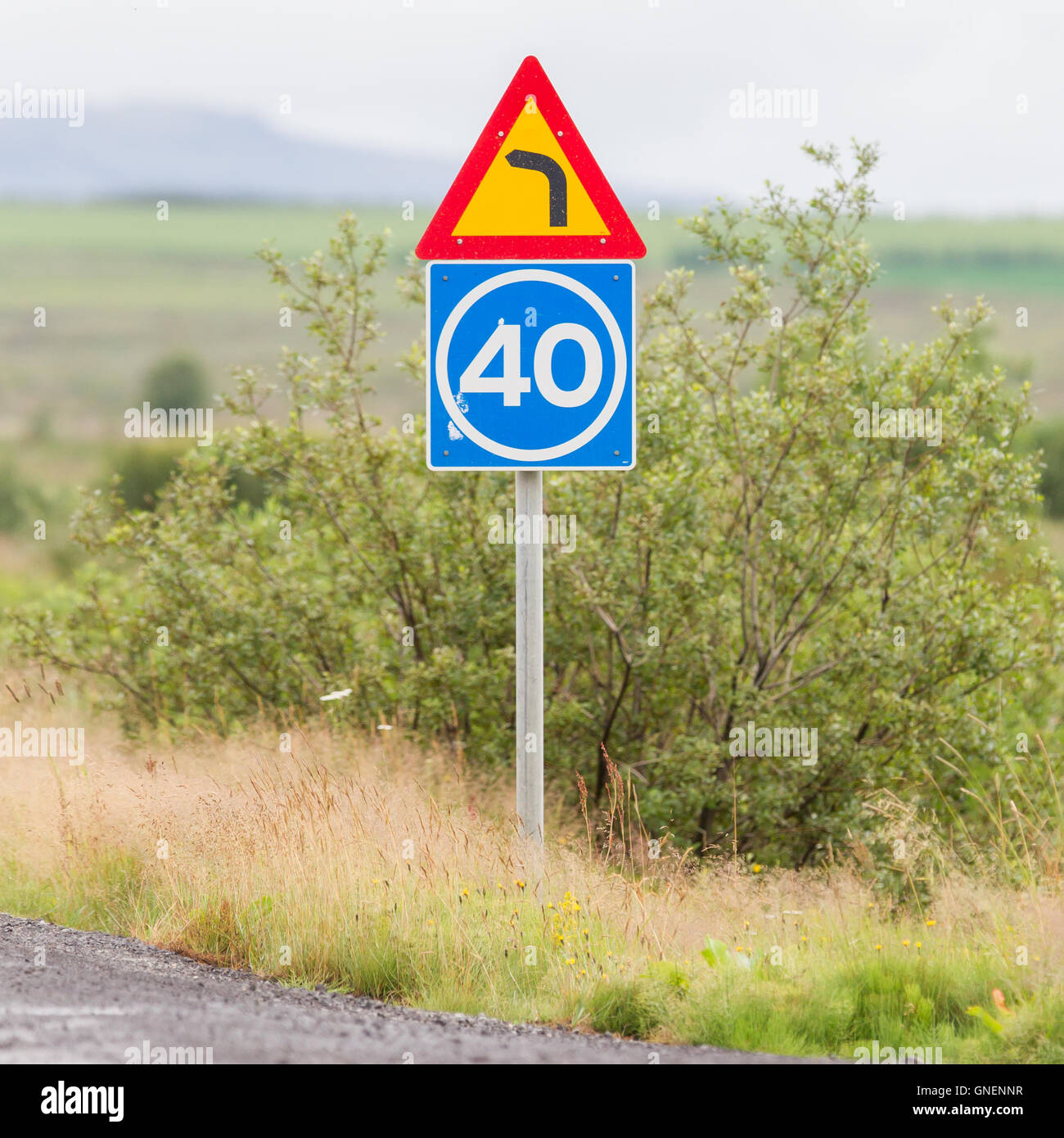 Curve with advisory speed limit in Iceland Stock Photo - Alamy