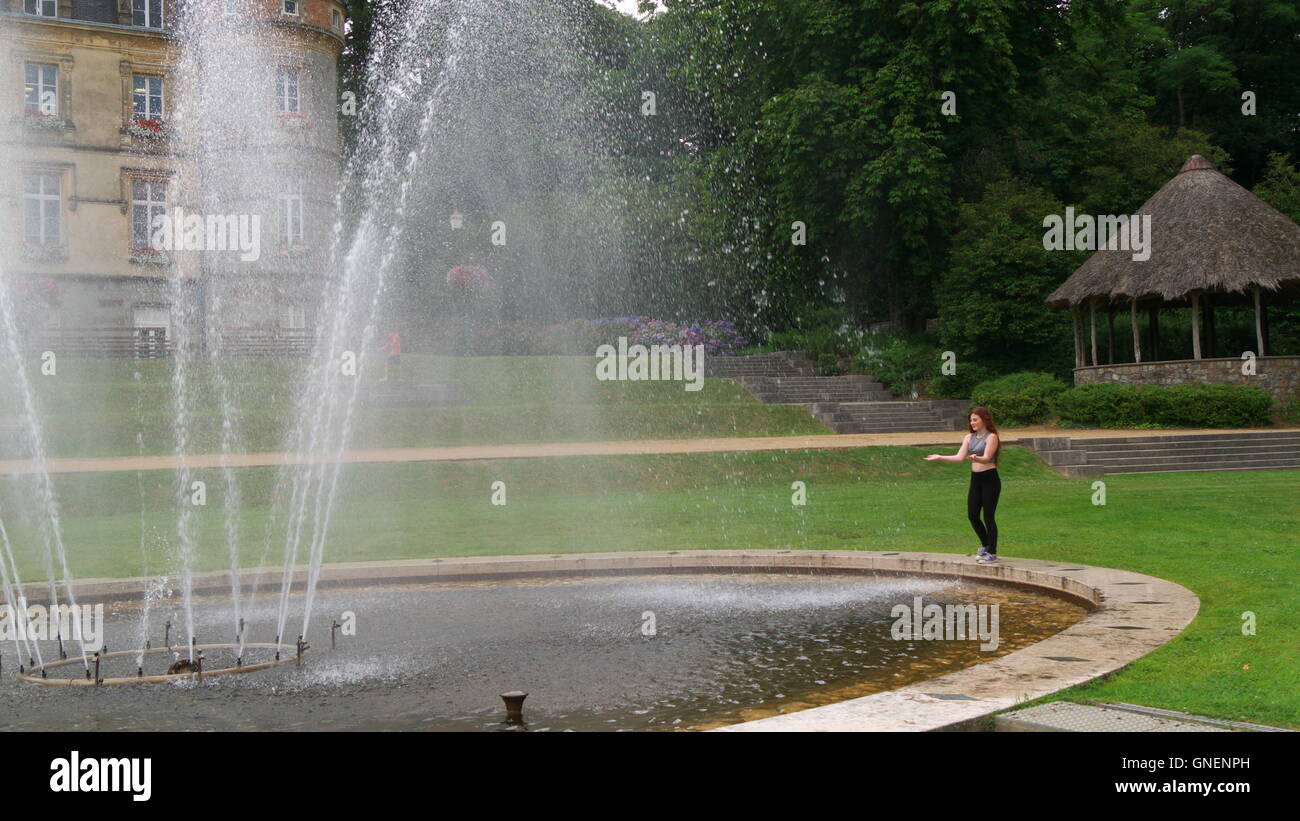 Young Girl Cooling Off In The Fountain At Bagnoles De LOrne Stock Photo ...